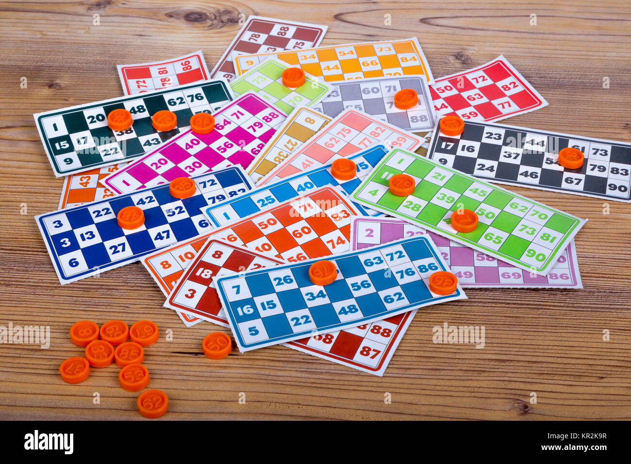 Colorful lotto or bingo game papers with numbers and plastic lotto ...