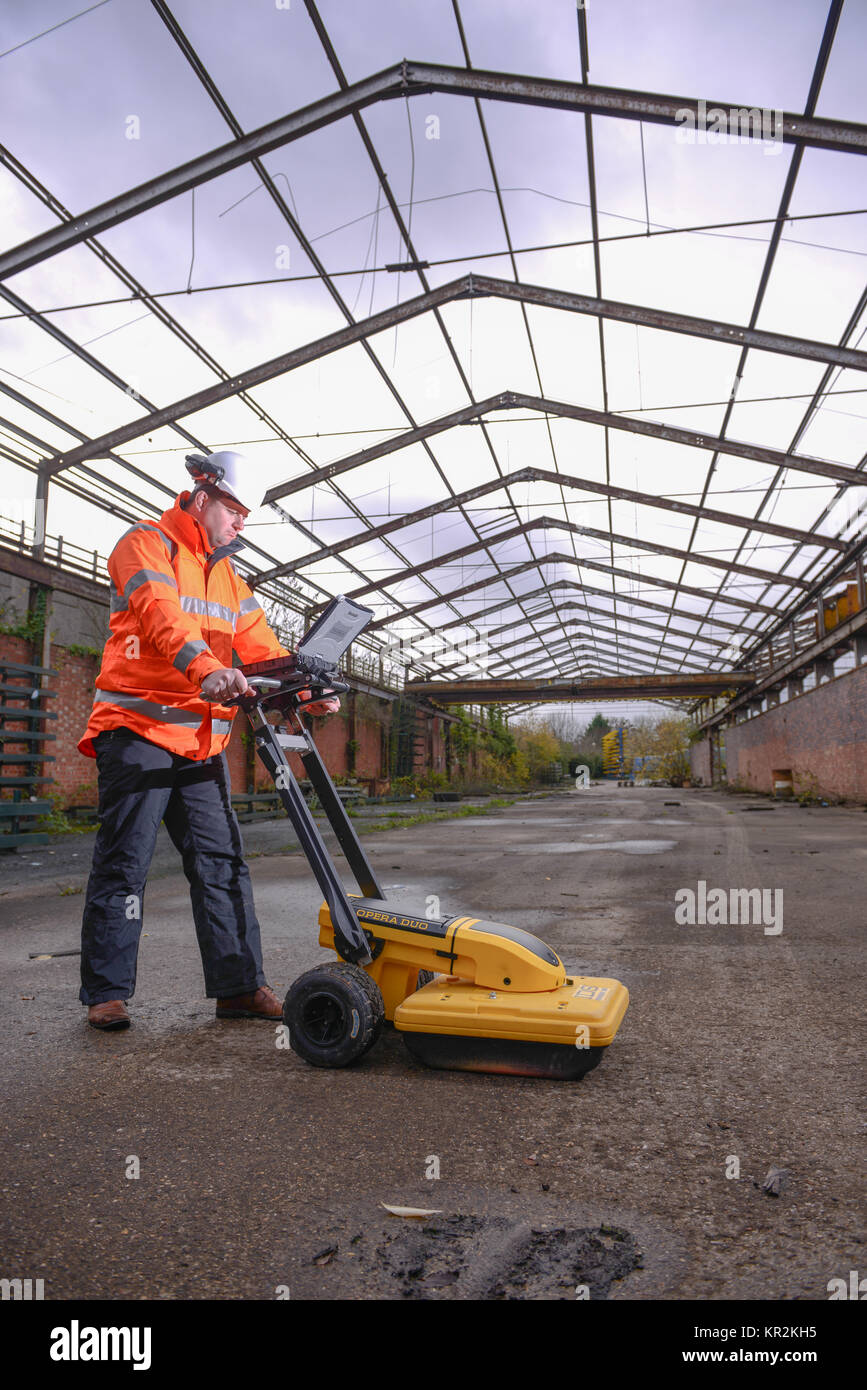 A ground surveyor using technology to detect underground utility pipes ...