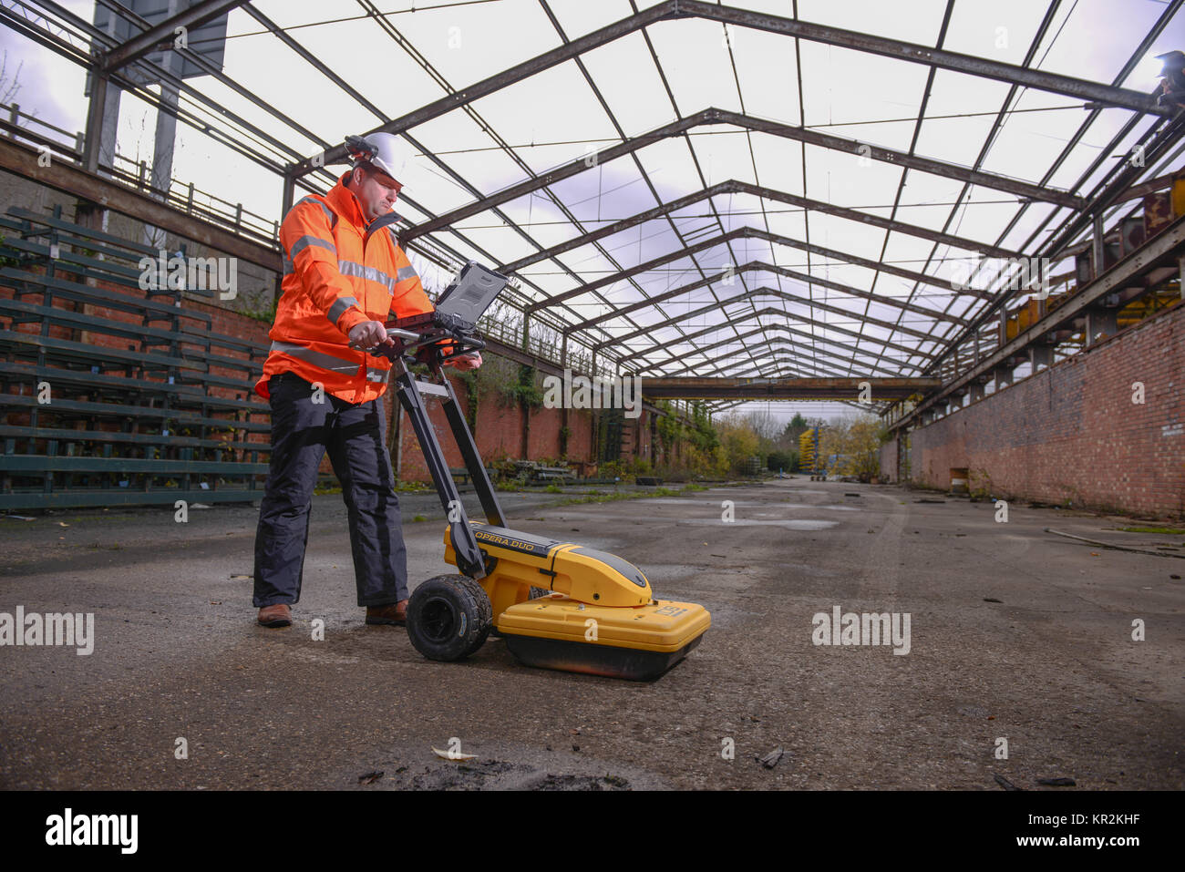 A ground surveyor using technology to detect underground utility pipes ...