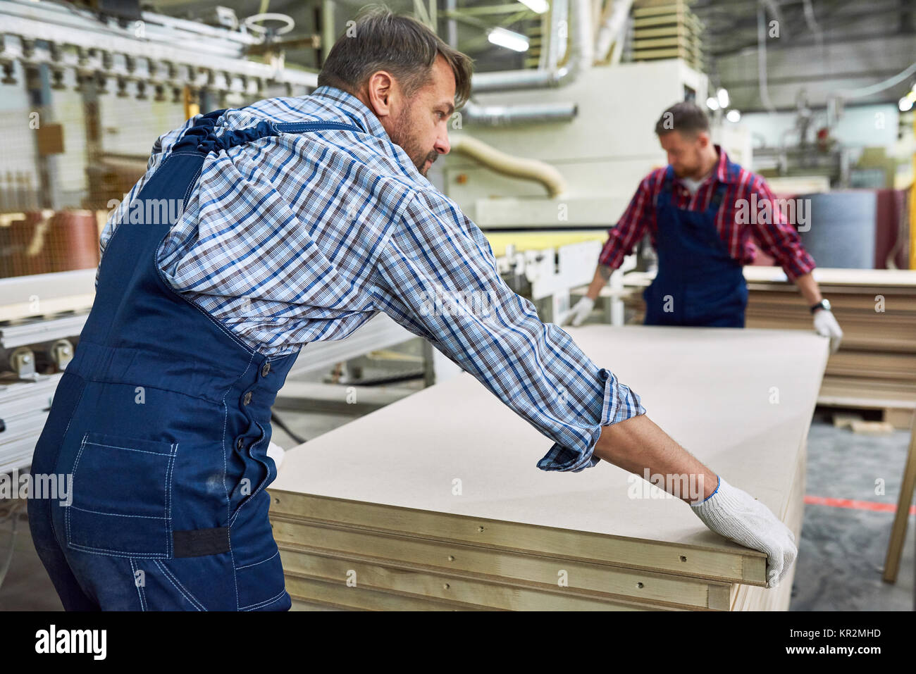 Factory Workers Moving Materials in Shop Stock Photo - Alamy