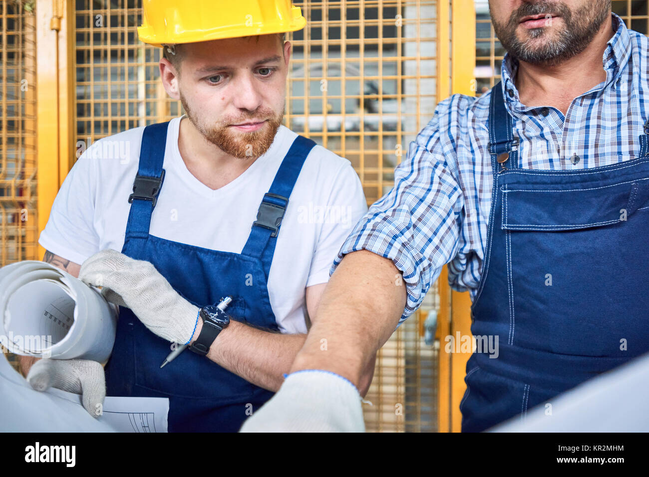 Construction Workers Checking Plans on Site Stock Photo - Alamy