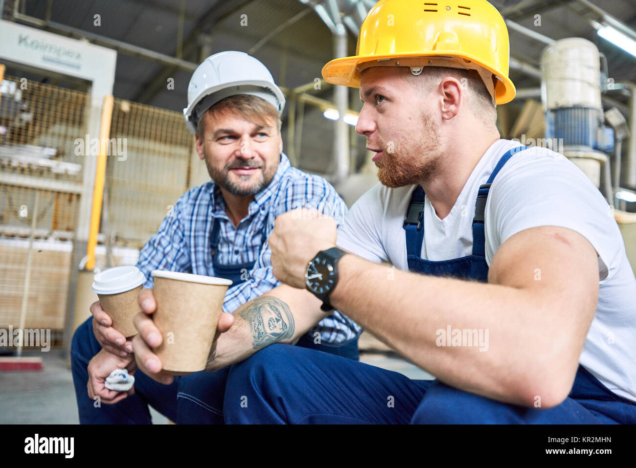 Construction Workers Chatting on Coffee Break Stock Photo - Alamy
