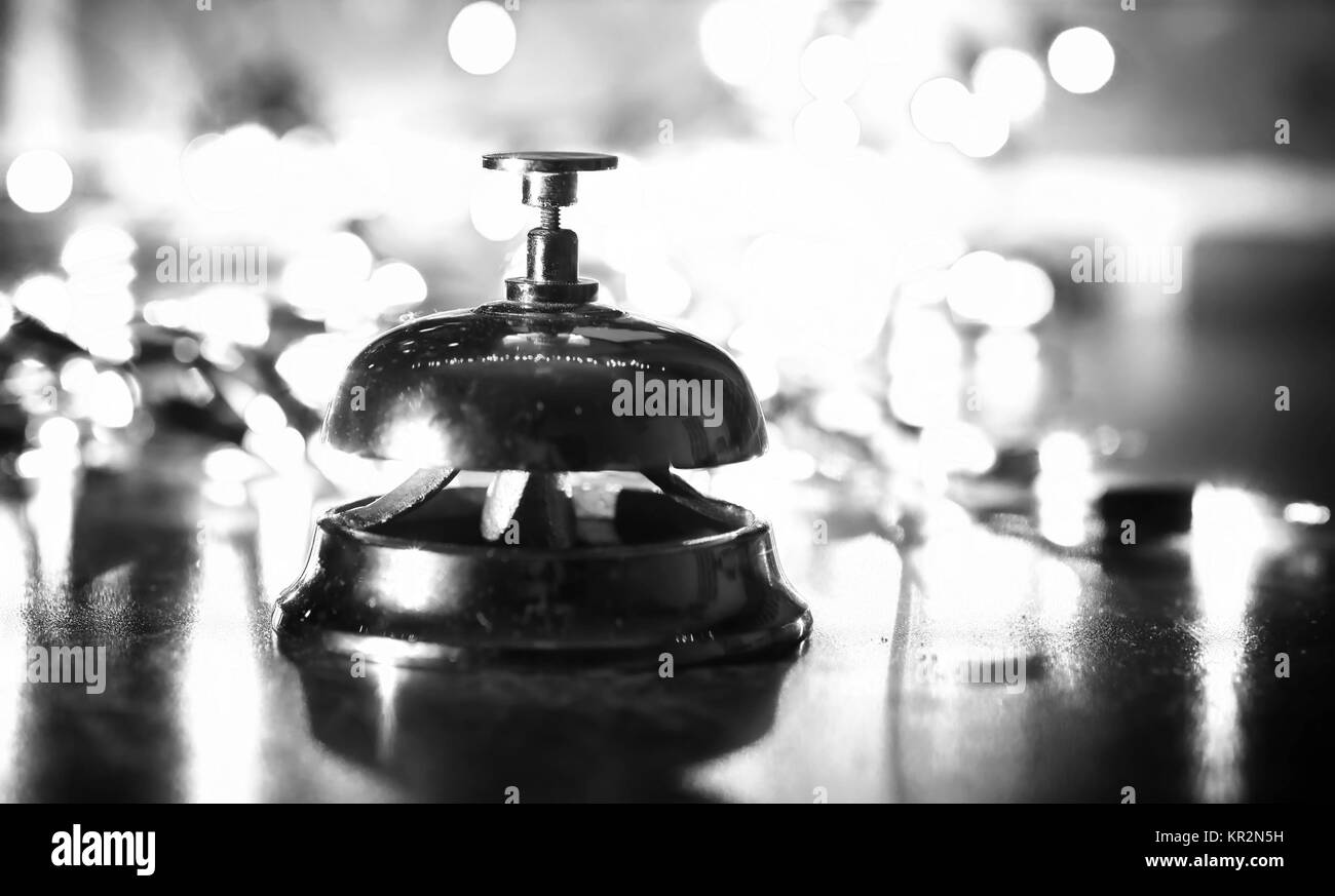 reception bell on the table and shining garland background Stock Photo ...