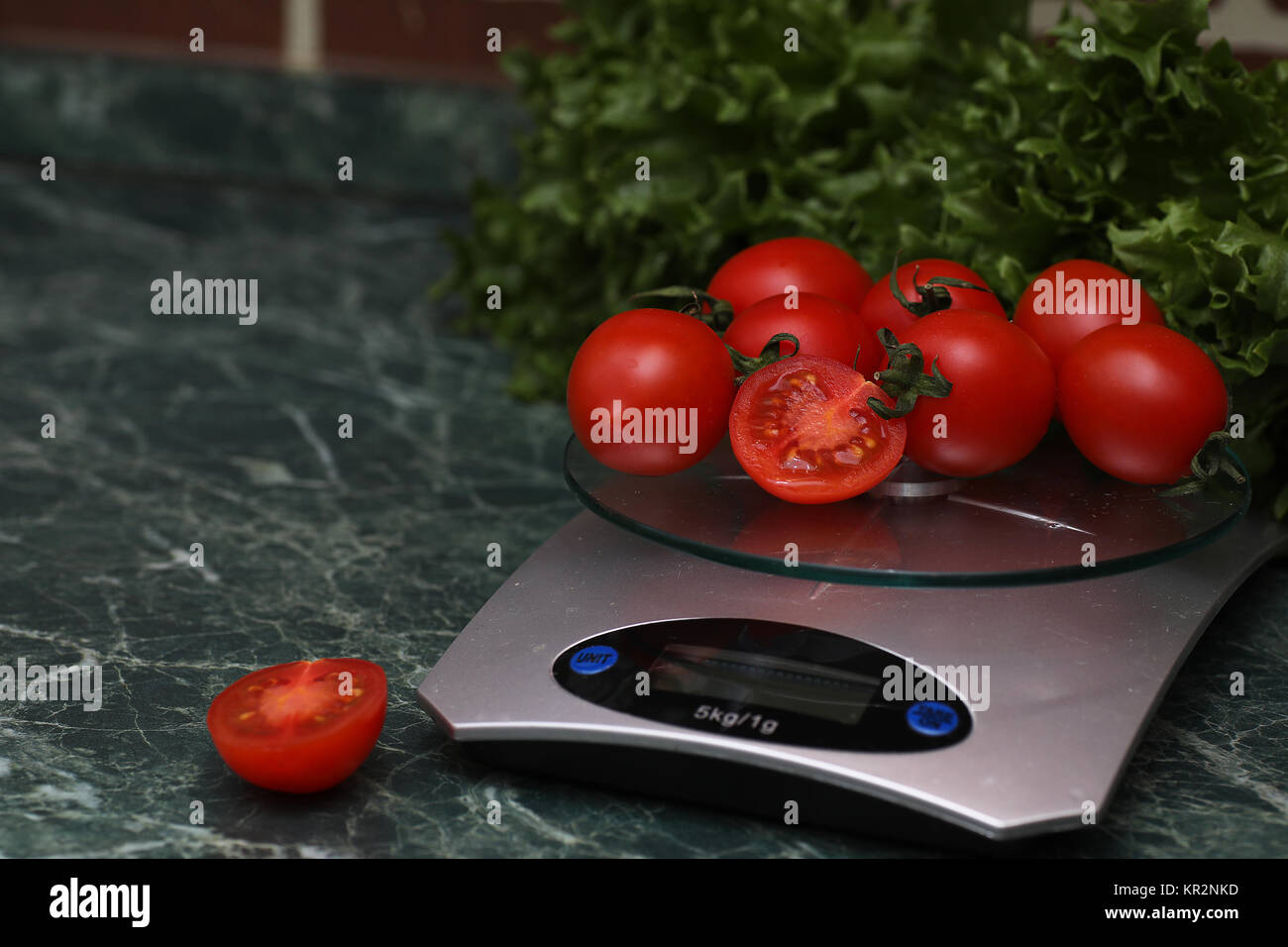 Fresh tomatoes on kitchen scales weighing Stock Photo - Alamy