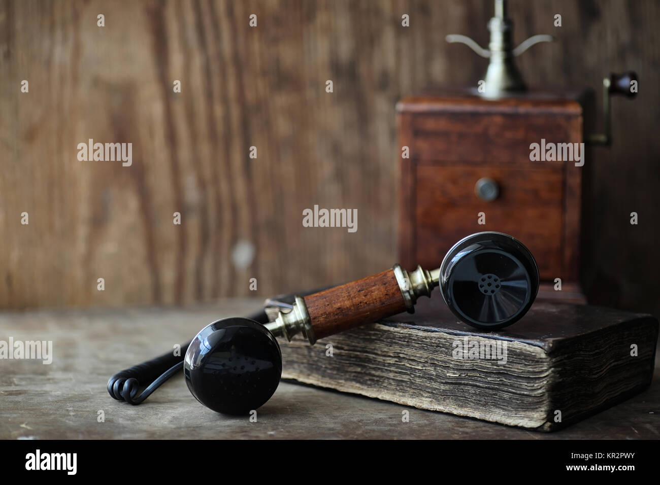 Old telephone and retro book on a wood Stock Photo - Alamy