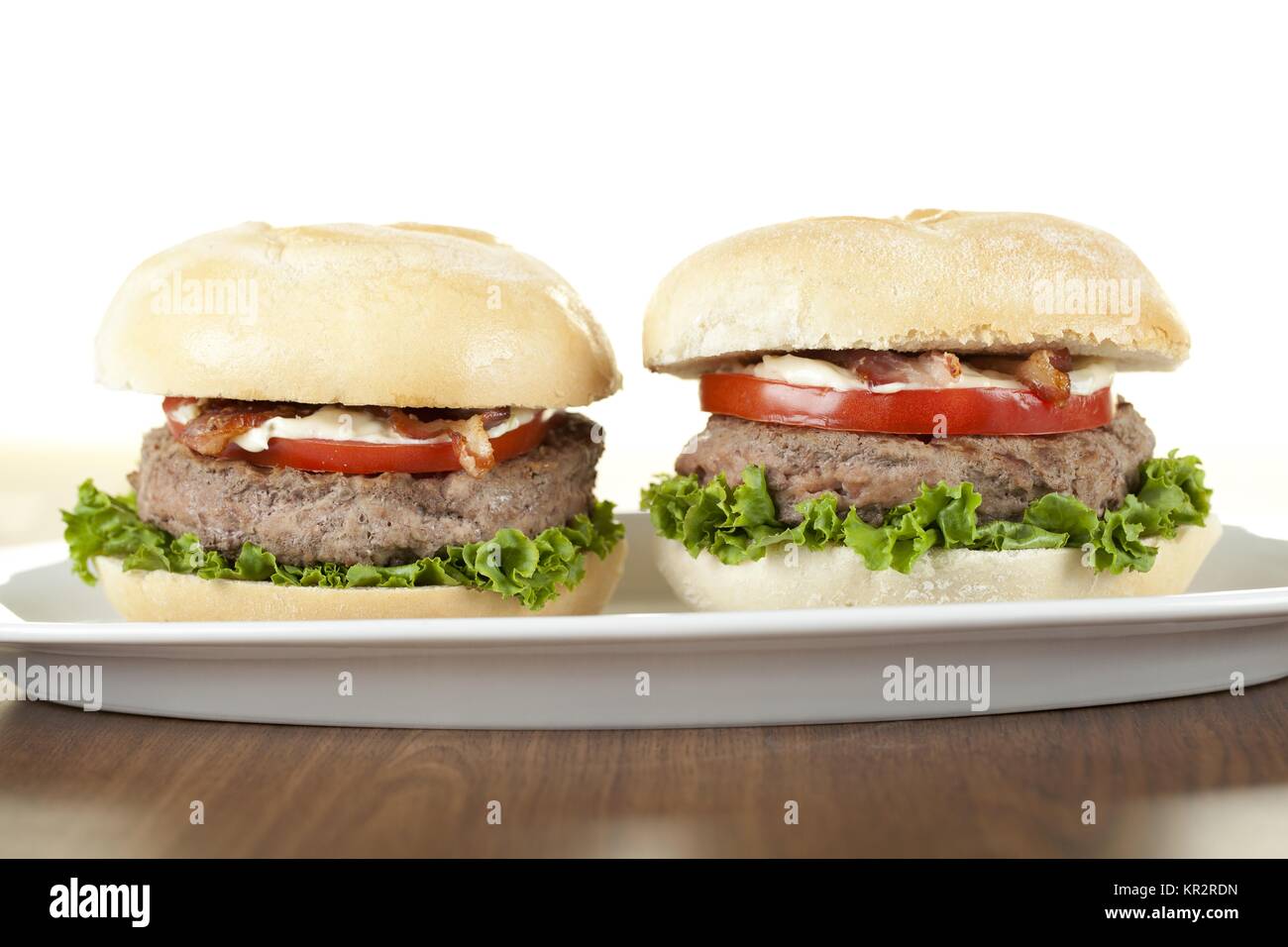 round plate with two chicken burgers Stock Photo - Alamy