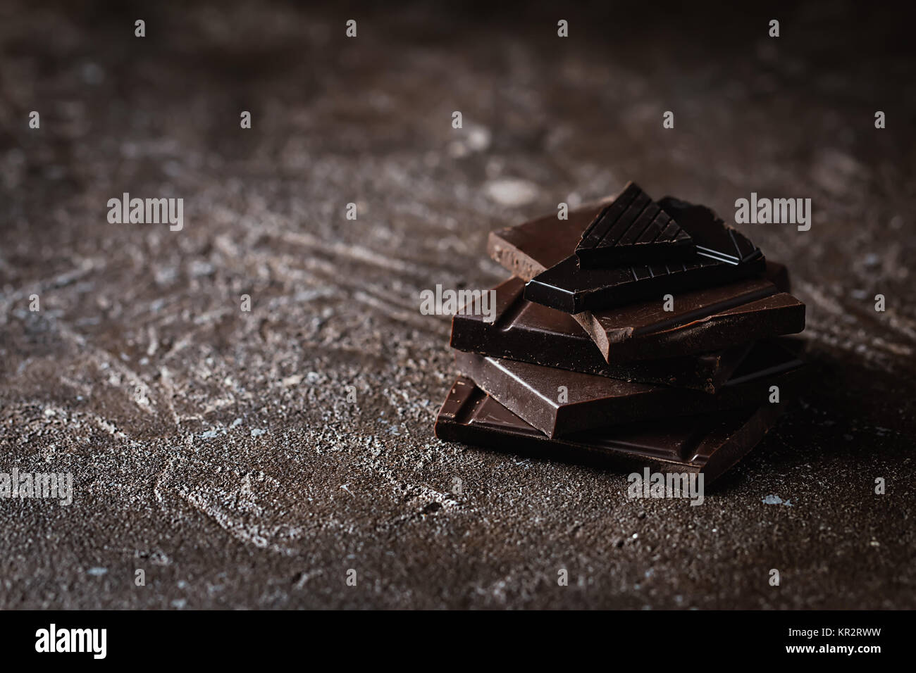 Dark chocolate stack from chocolate pieces on dark background Stock ...