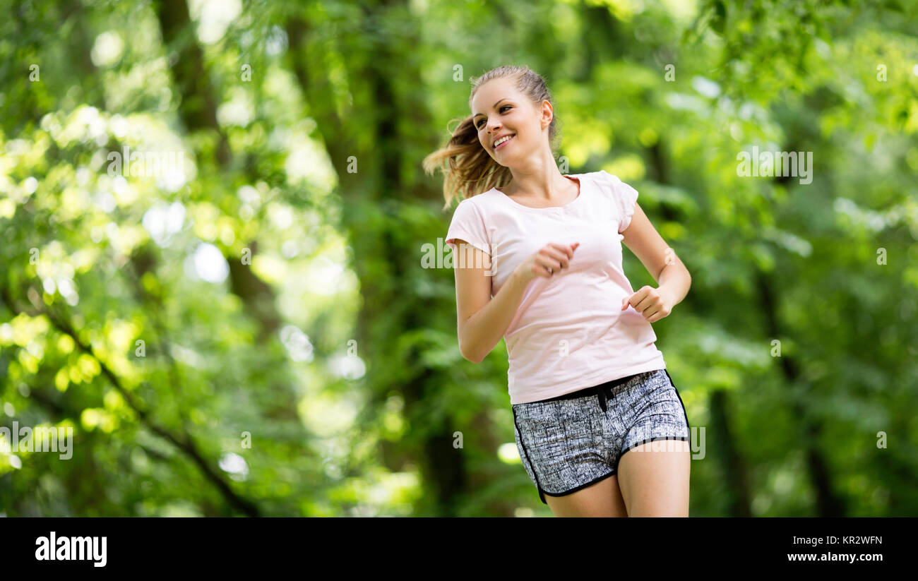 Beautiful jogging woman in nature Stock Photo - Alamy
