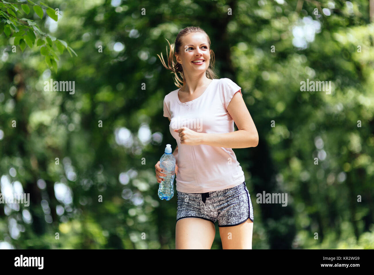 Beautiful jogging woman in nature Stock Photo - Alamy