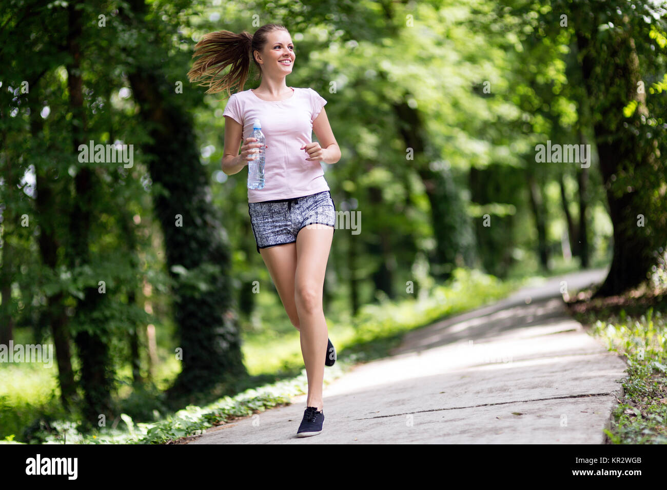 Beautiful jogging woman in nature Stock Photo - Alamy