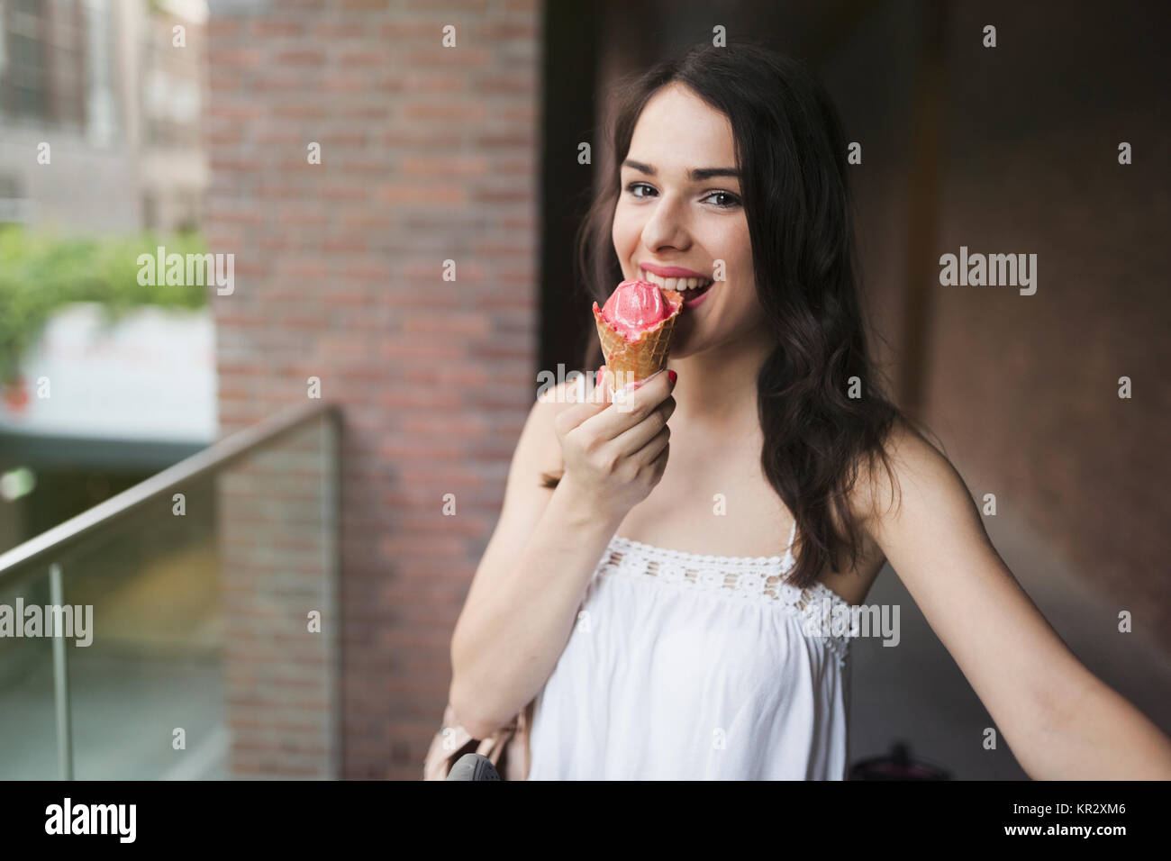 Portrait of pretty girl eating ice cream Stock Photo - Alamy
