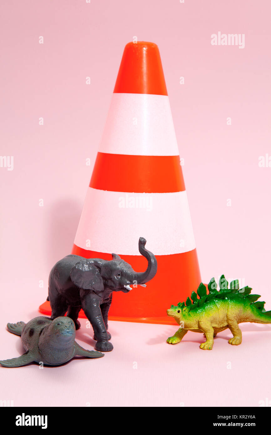 a collection animals beside a traffic cone on a vibrant pink background ...