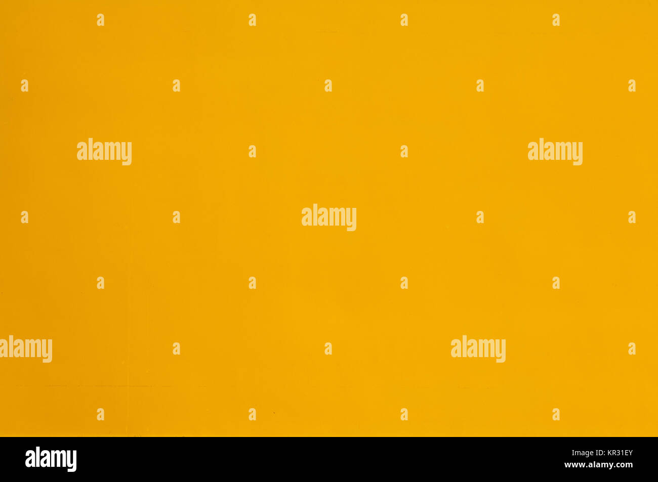 Yellow or ocher homogeneous background surface Stock Photo - Alamy