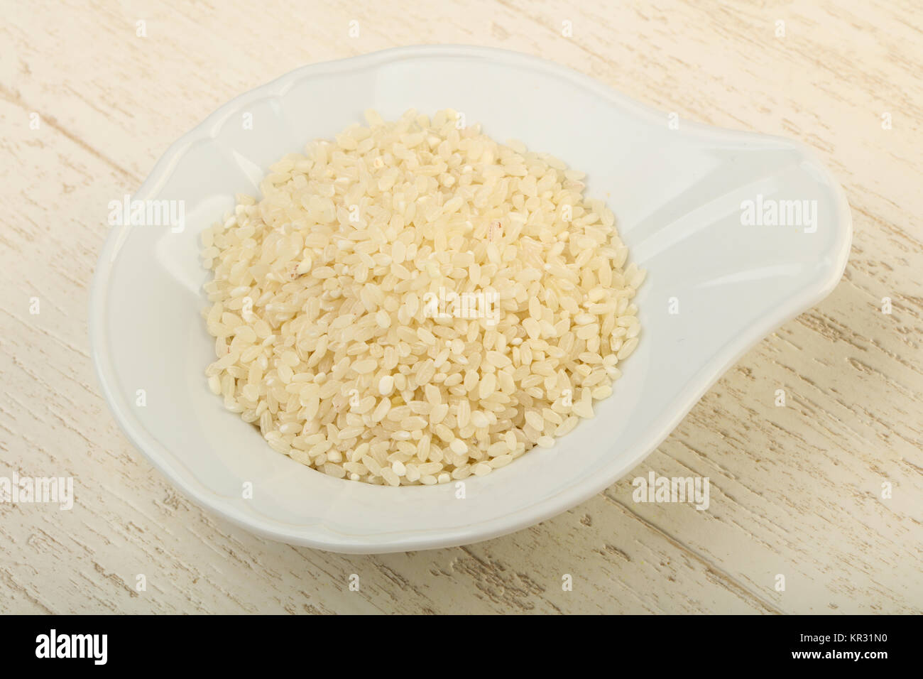 Raw rice heap in the bowl - ready for cooking Stock Photo - Alamy