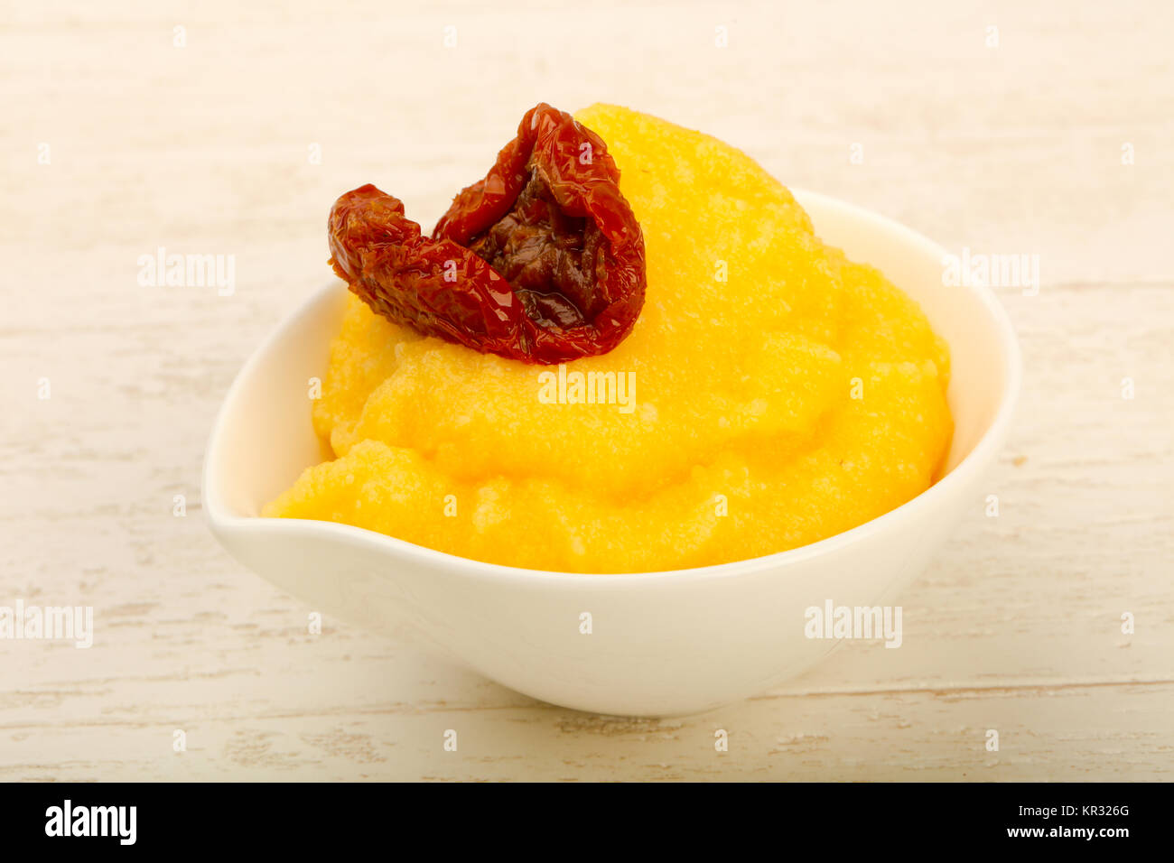 Polenta with dry tomato Stock Photo - Alamy
