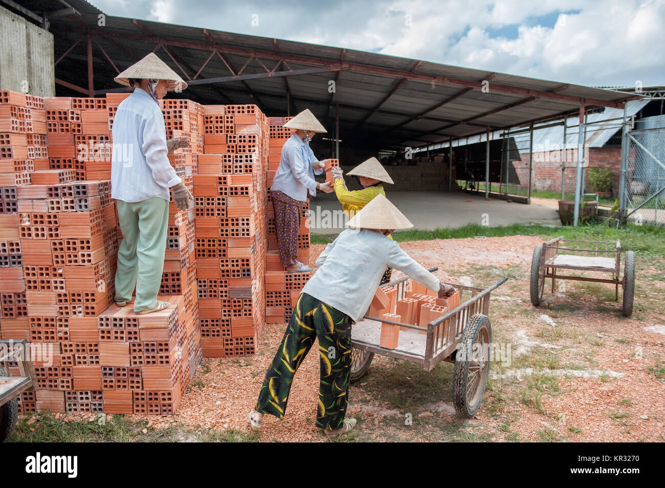 Vietnamese women work in an old brickworks in the Mekong delta. The ...