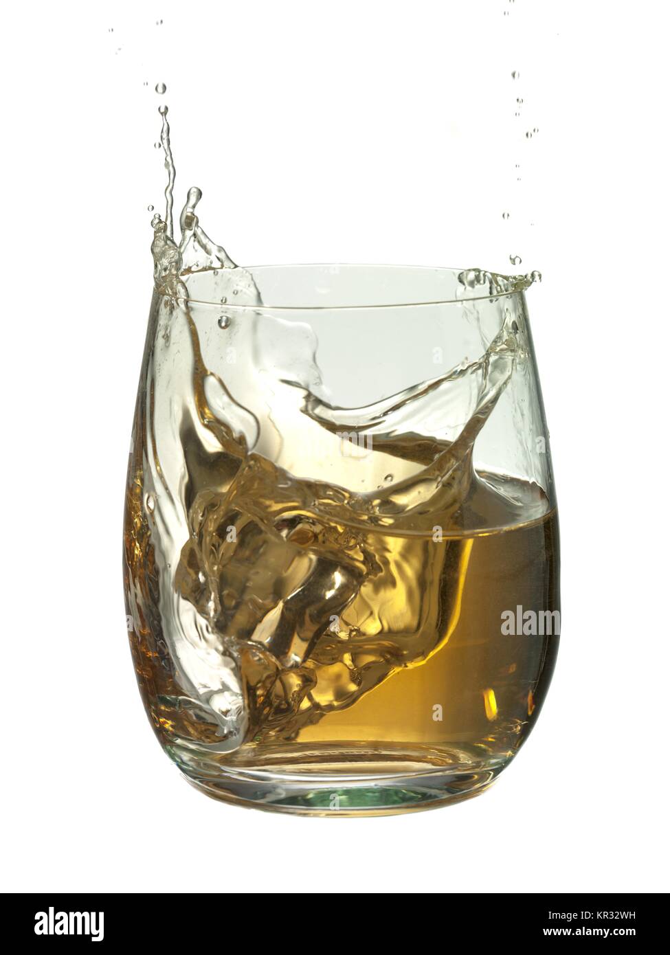 splashing glass of whiskey Stock Photo - Alamy