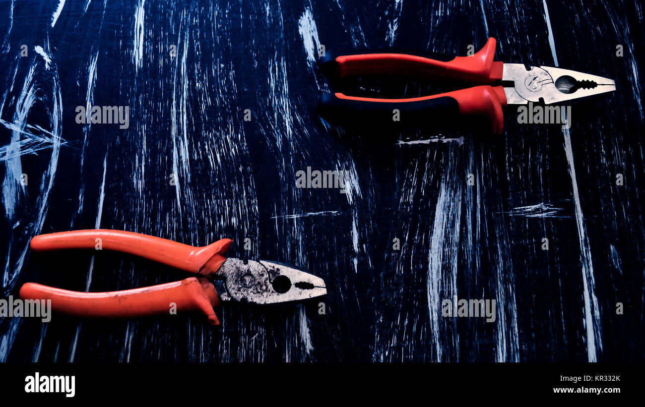 Pliers for repair work lying on the table. Repair tools in the h Stock ...