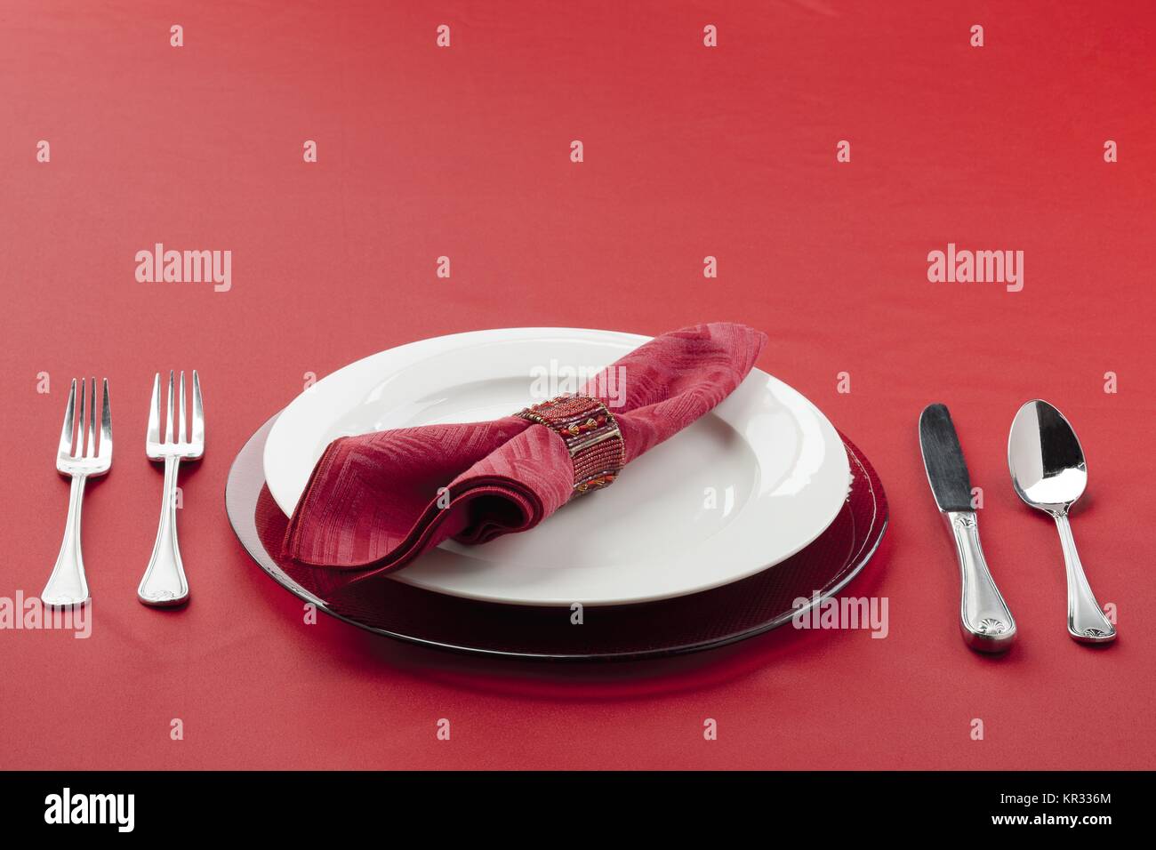 table setting with utensils plate and red cloth Stock Photo - Alamy