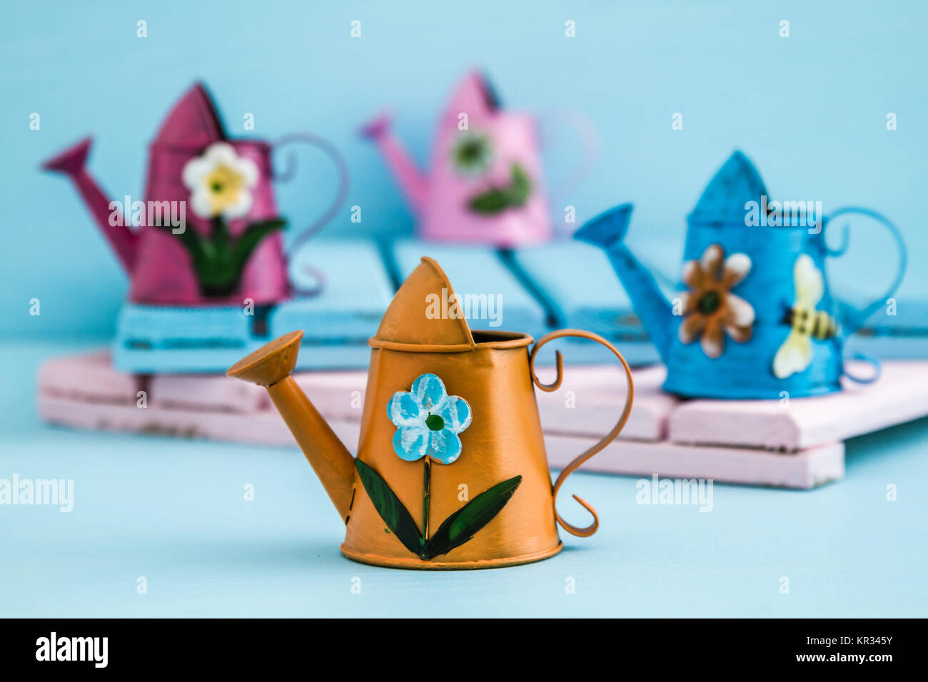 Colorful Metallic Watering Cans with Floral Design Stock Photo - Alamy