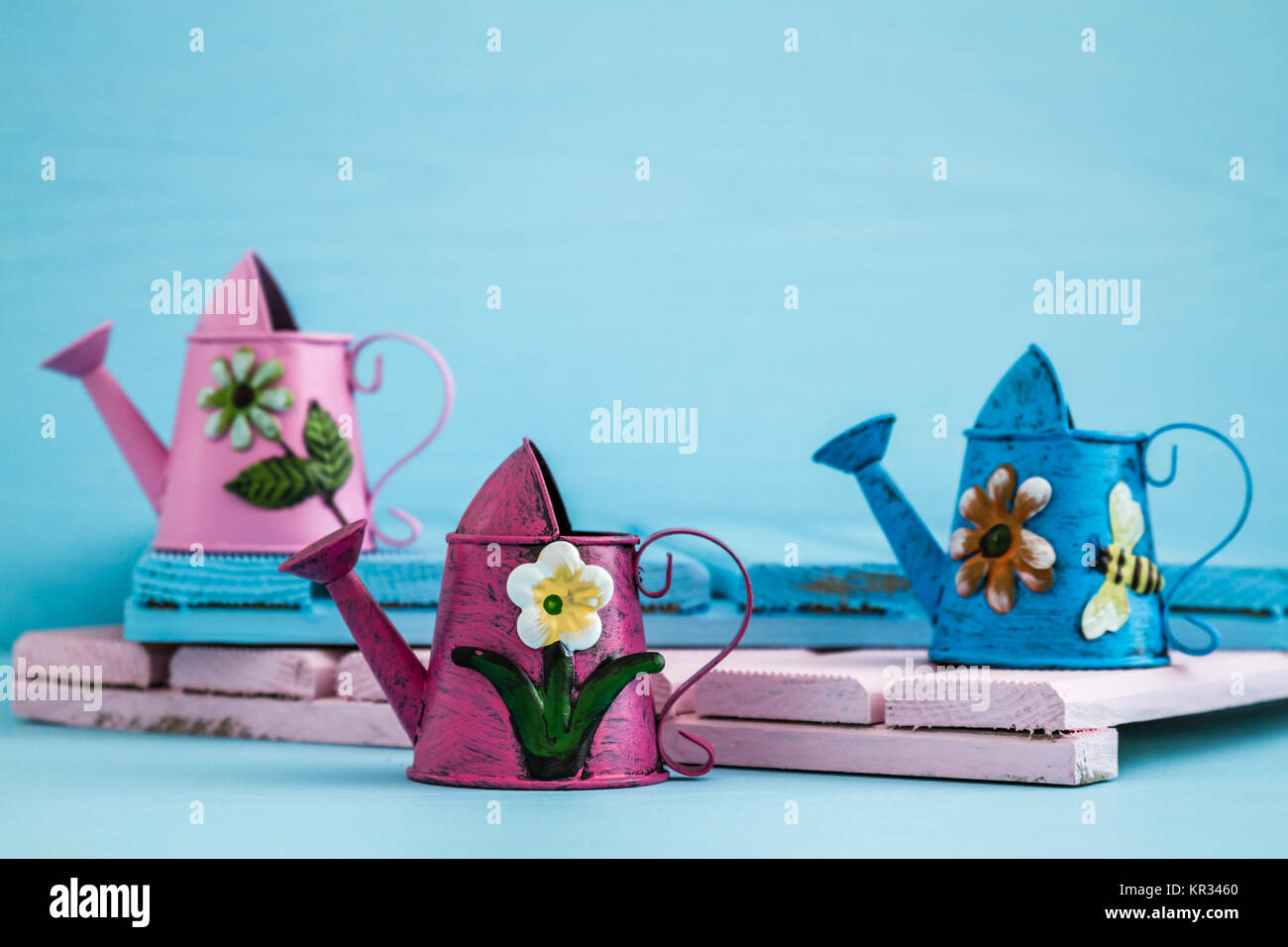 Colorful Metallic Watering Cans with Floral Design Stock Photo - Alamy