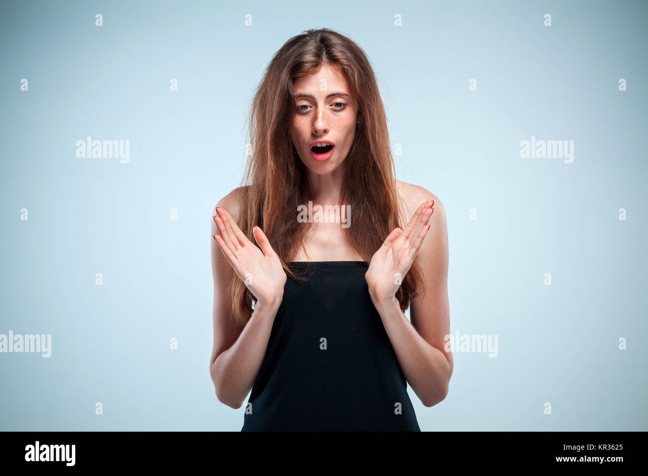 Portrait of young woman with shocked facial expression Stock Photo - Alamy
