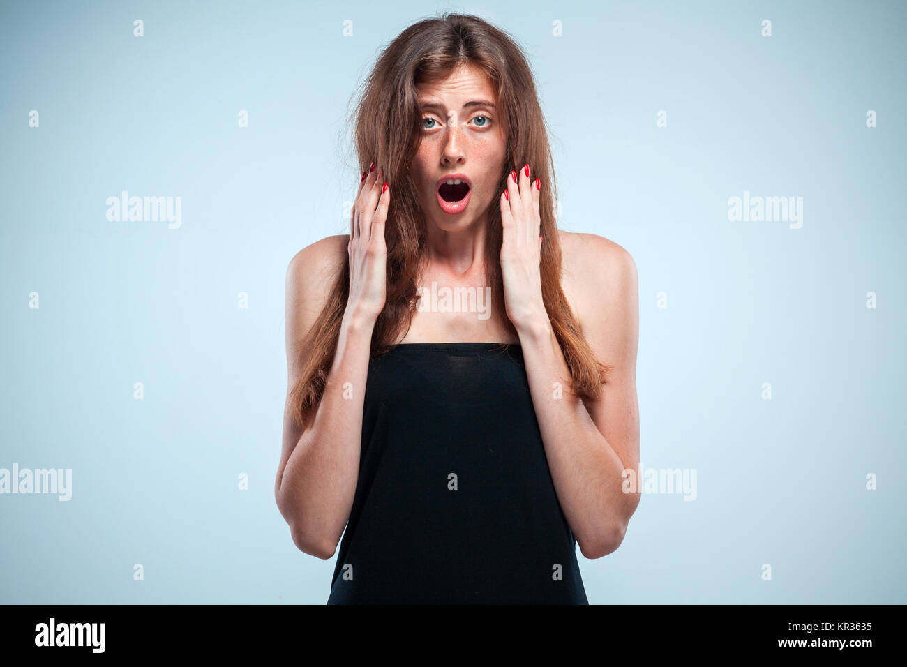 Portrait of young woman with shocked facial expression Stock Photo - Alamy