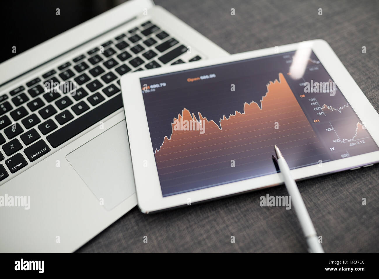 Stock market graph with digital tablet Stock Photo - Alamy