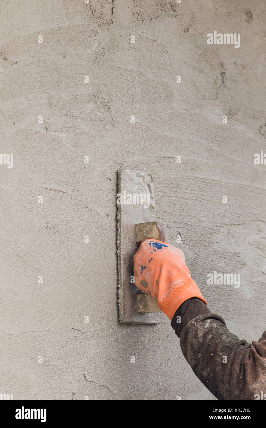Builder worker plastering concrete Stock Photo - Alamy