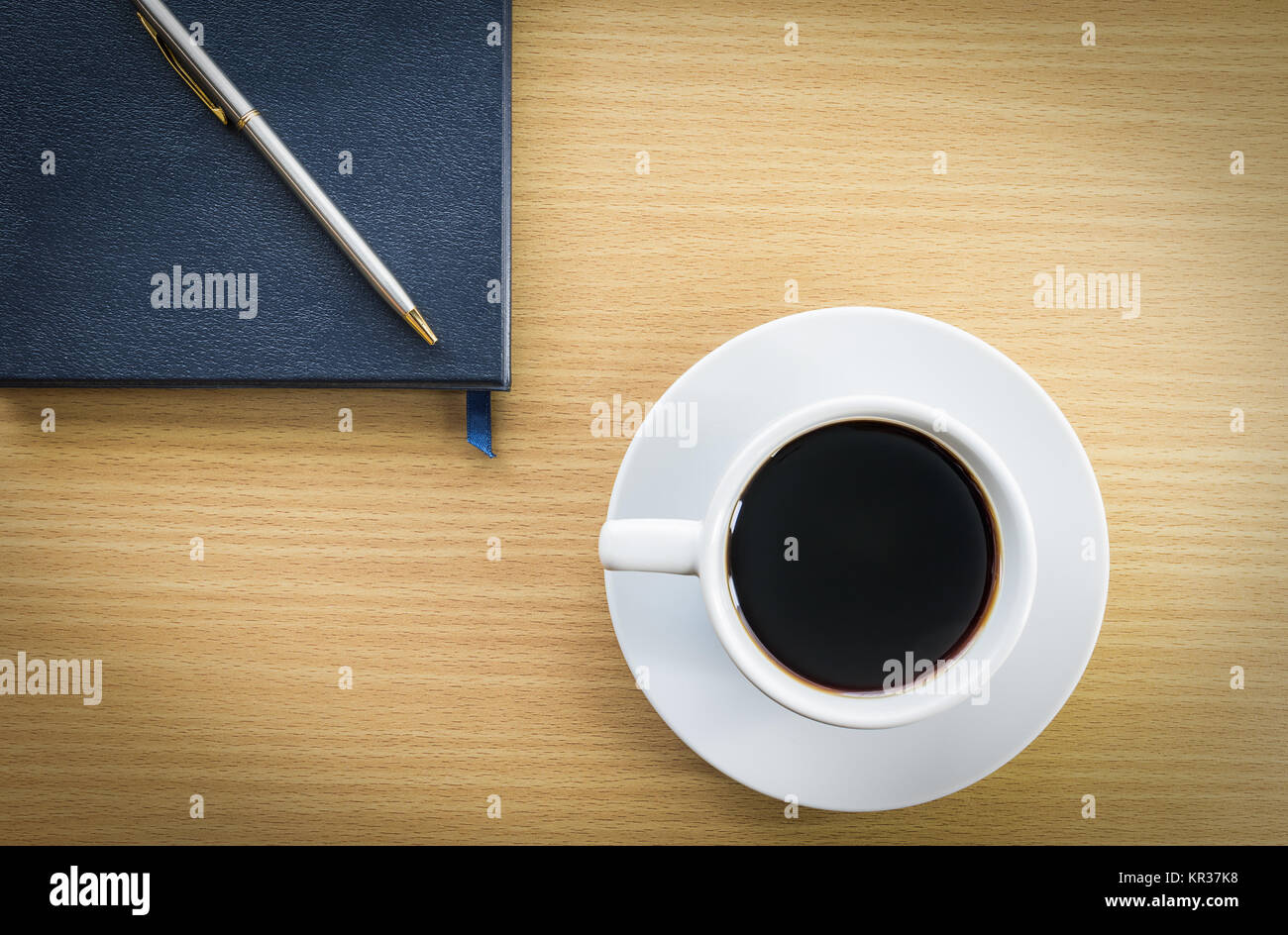 Coffee cup and notebook Stock Photo - Alamy