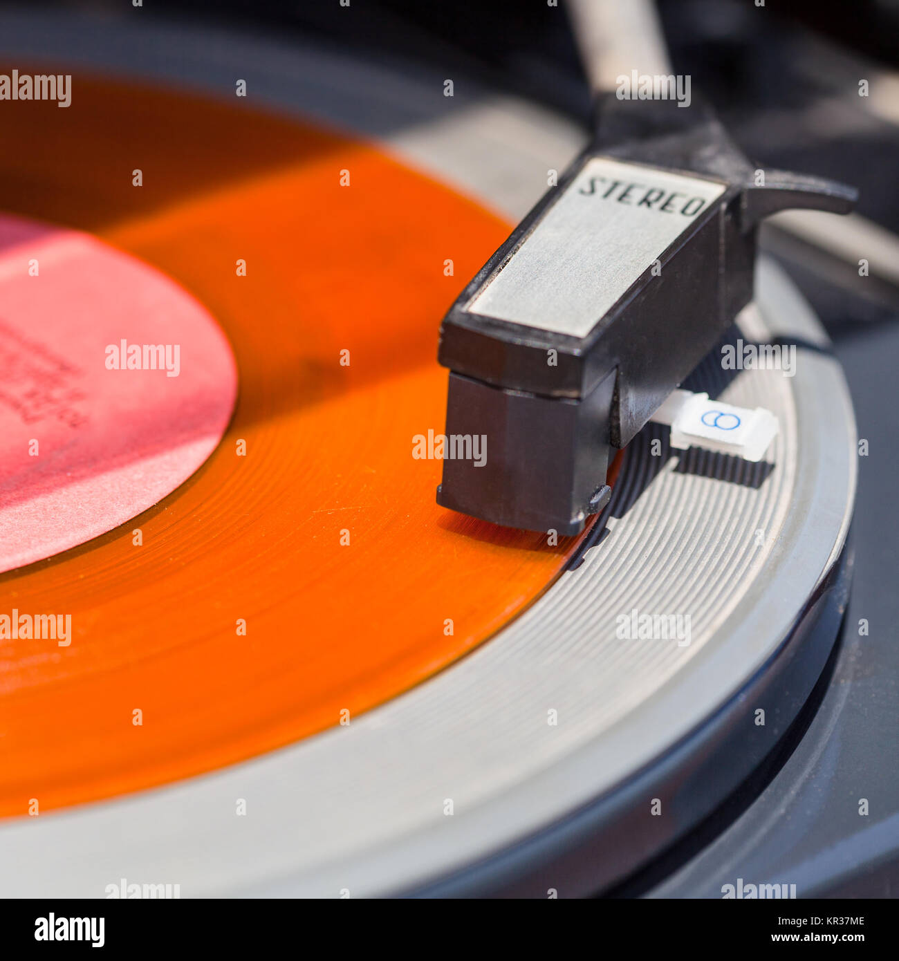tonearm of turntable on orange vinyl record Stock Photo - Alamy