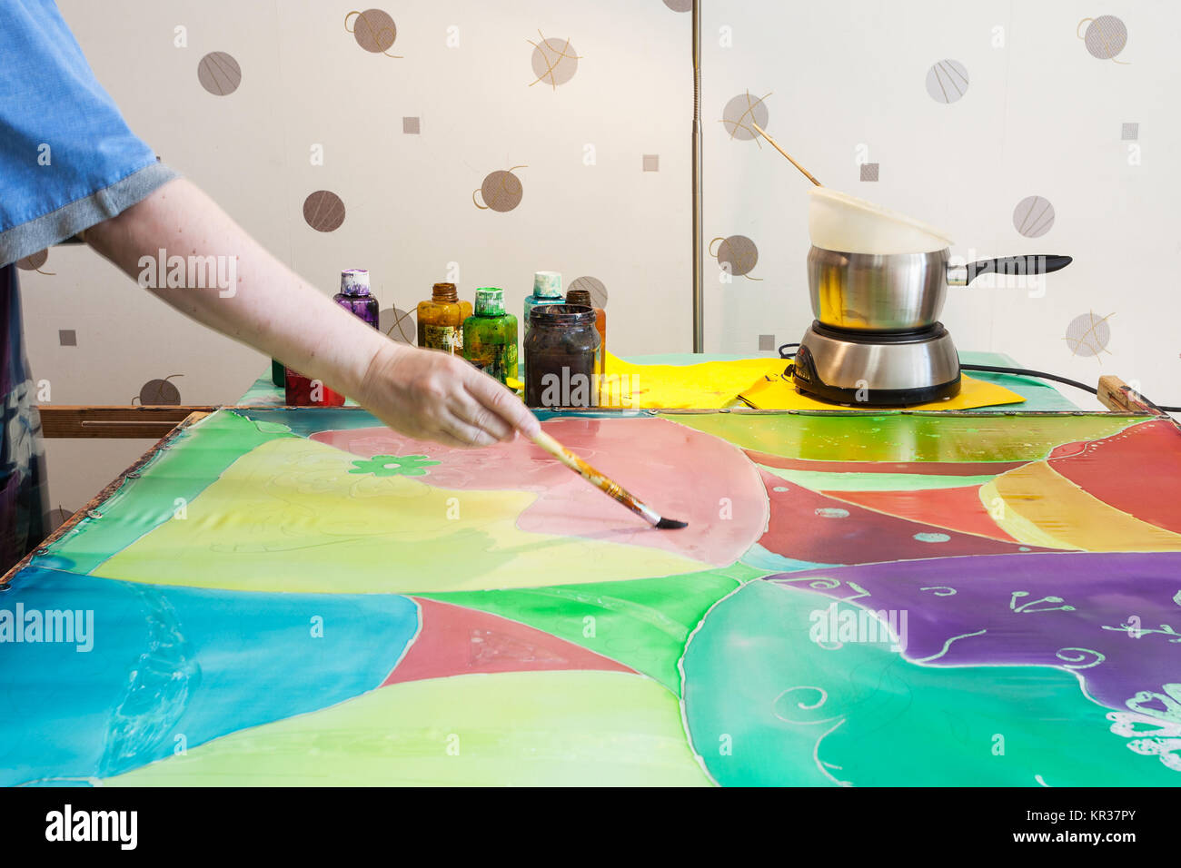 artist gets second layer of paint on silk canvas Stock Photo - Alamy