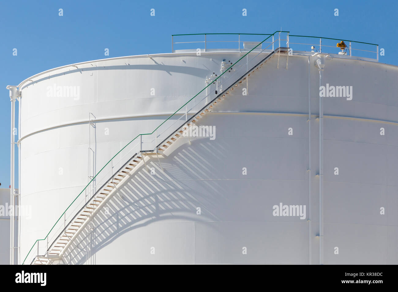 white tanks in tank farm with iron staircase under blue sky Stock Photo ...