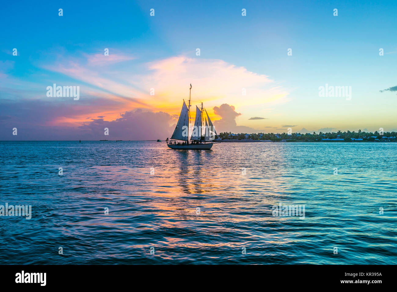 sunset at key west with sailing boat Stock Photo - Alamy