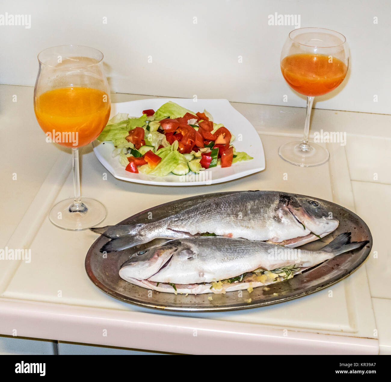 fish on a plate at home kitchen Stock Photo - Alamy