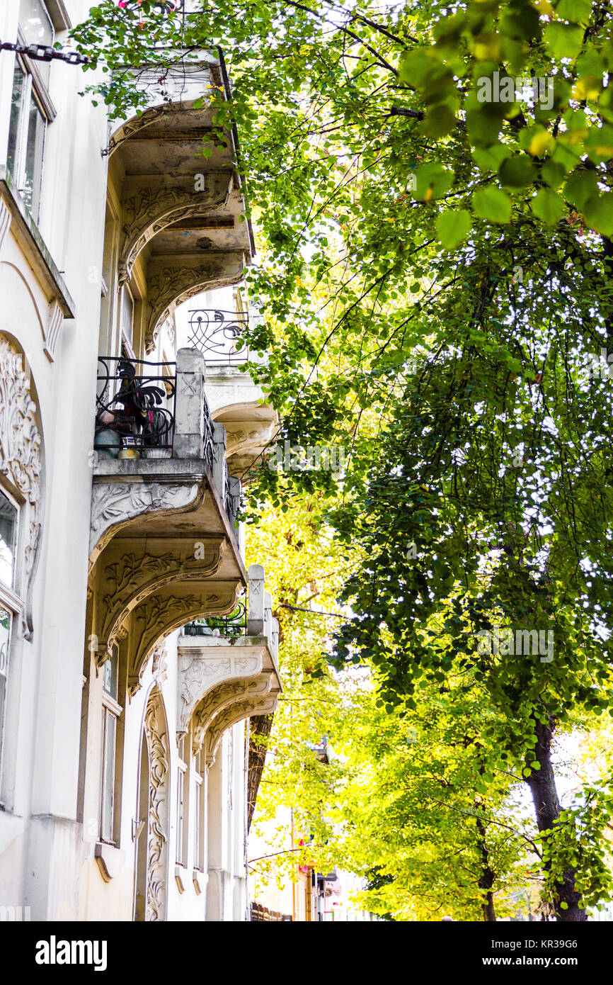 Traditional balcon of archiepiscopal palace to the strees with trees ...