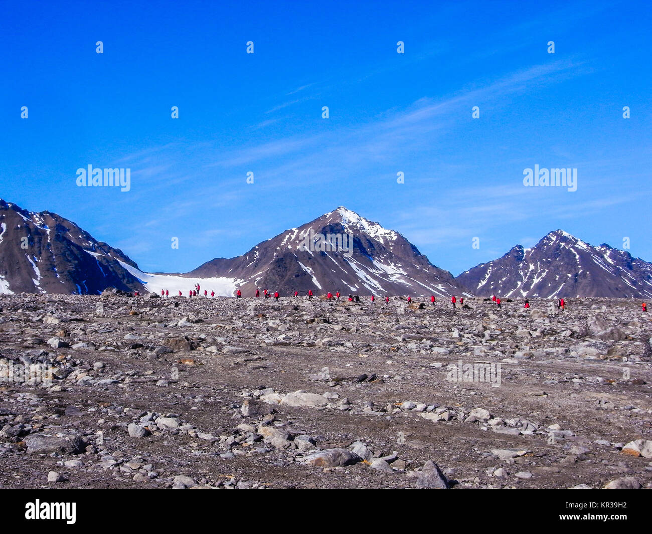 A travel group of people randonee ski walking high above the fjords ...