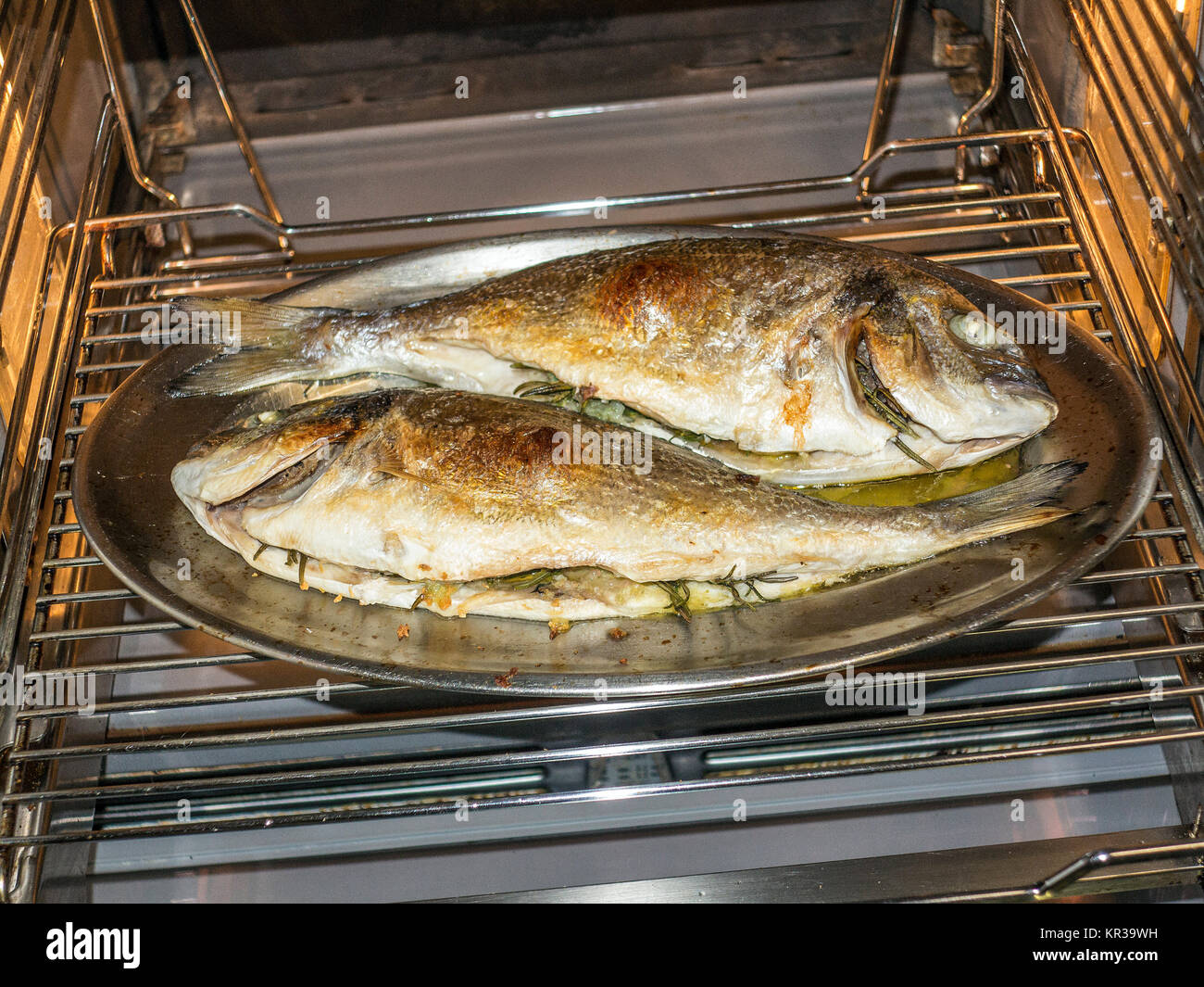 cooking fish in oven at home kitchen Stock Photo - Alamy