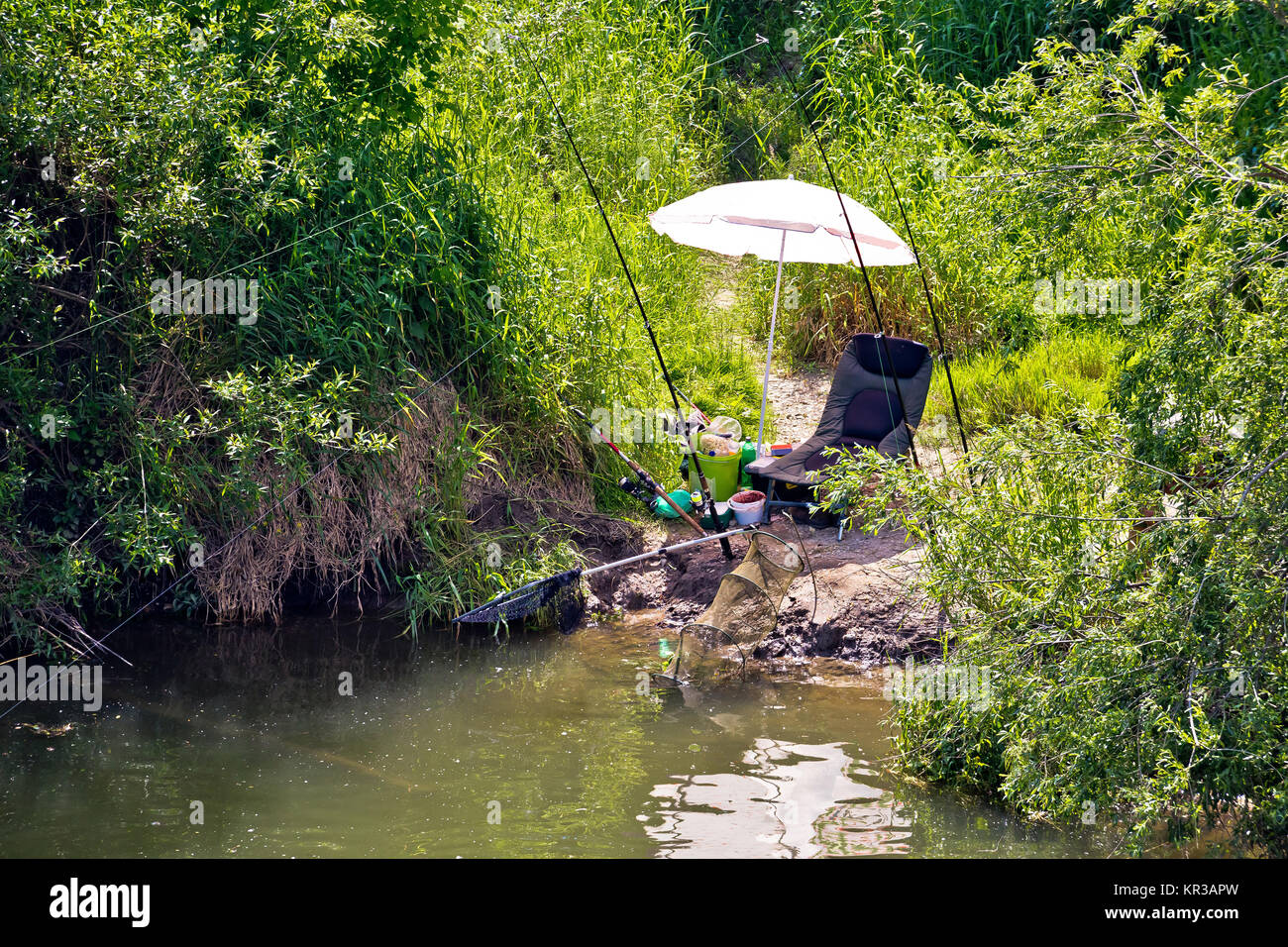 Fishing spot and gear in green landscape Stock Photo - Alamy