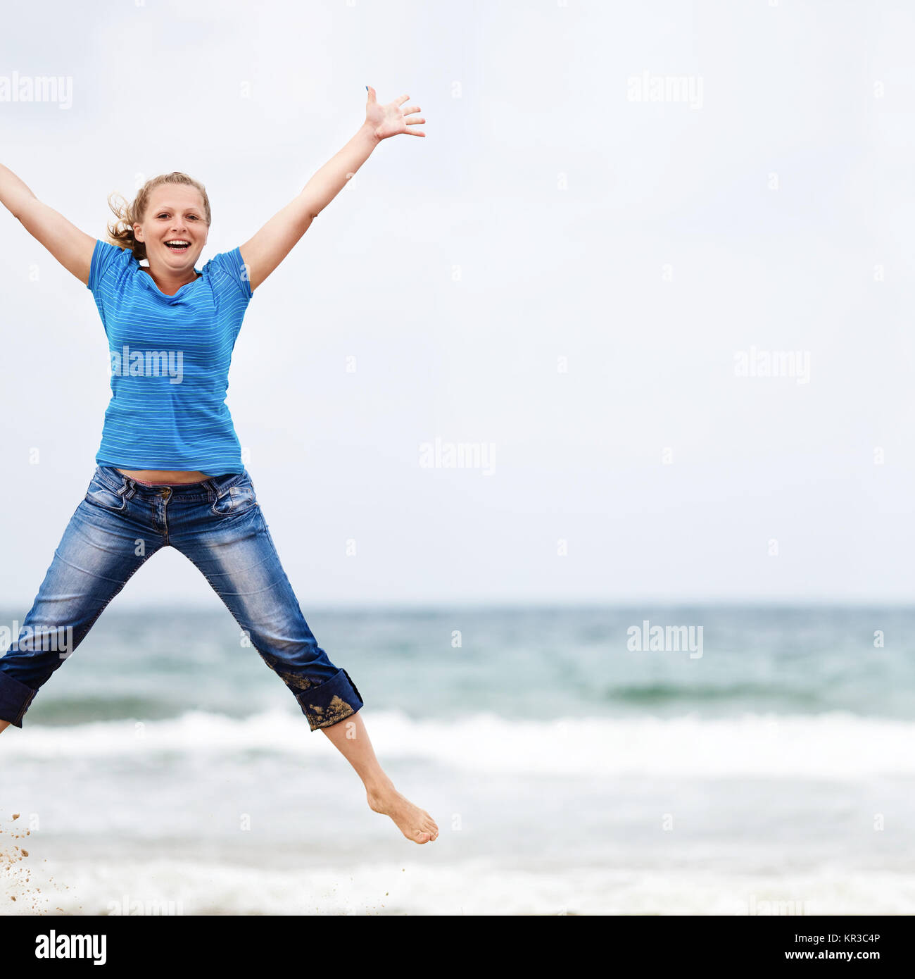 Happy woman jumping Stock Photo - Alamy