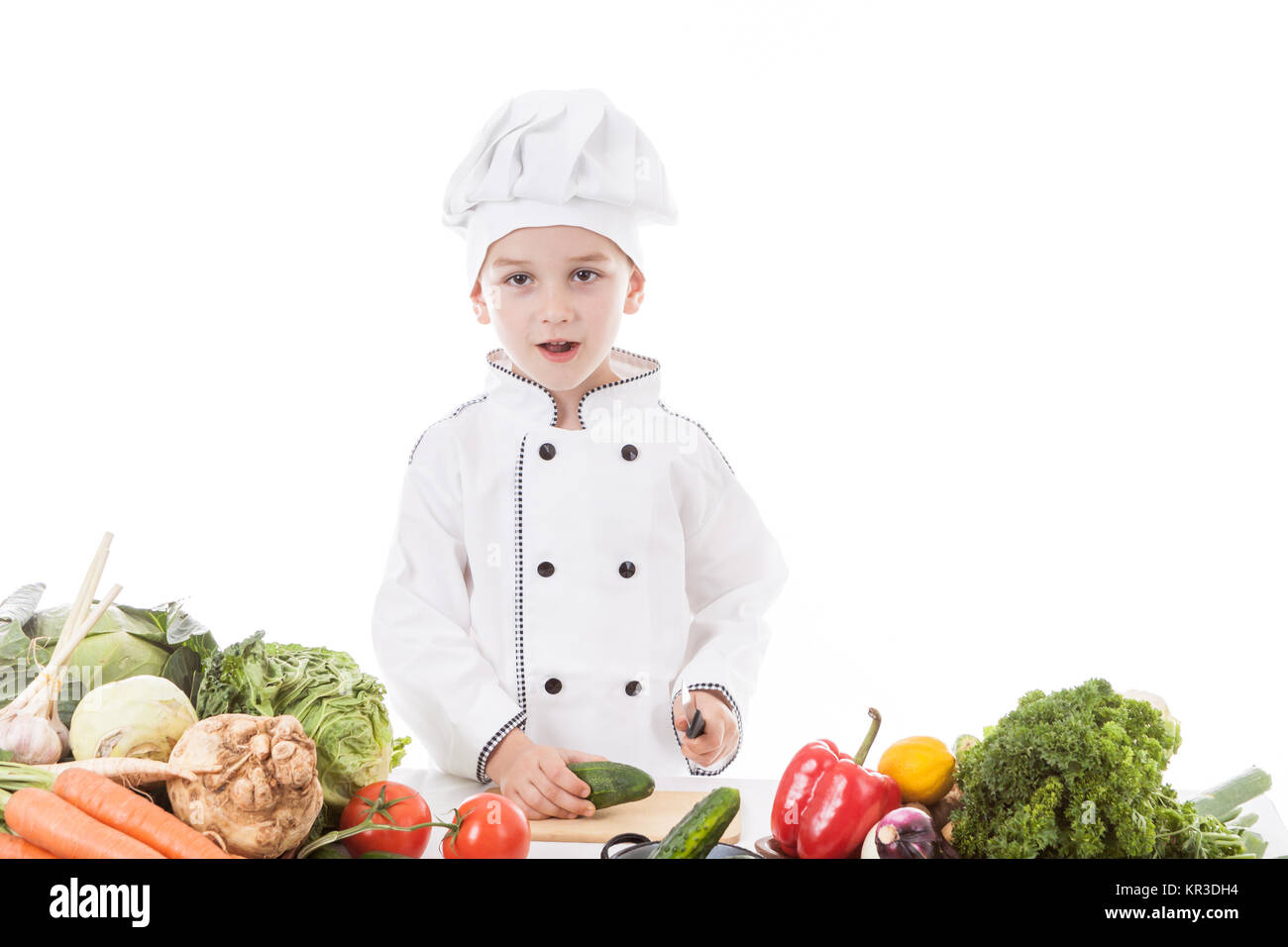 One little boy as chef cook making salad, cooking with vegetable Stock ...