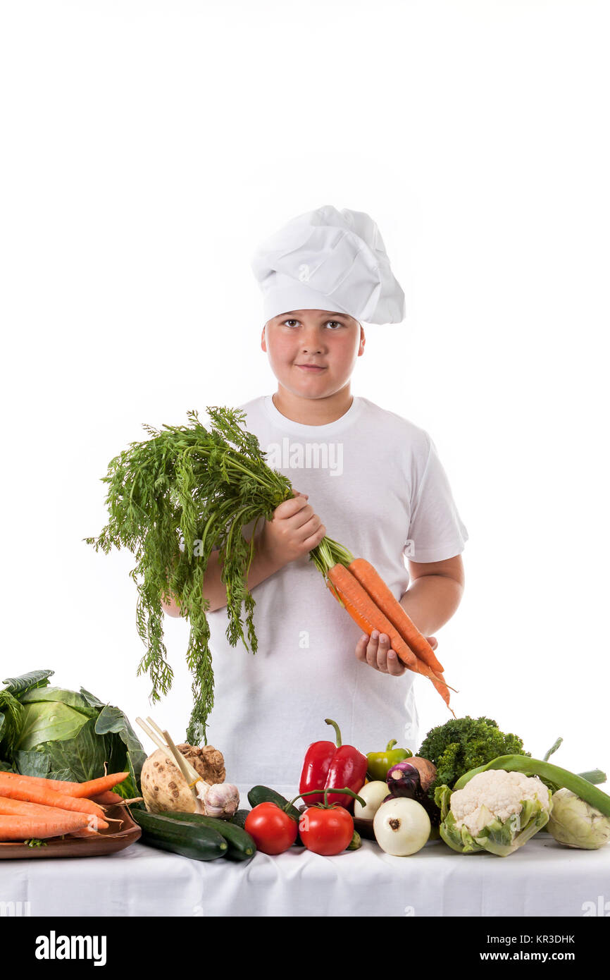 One little boy as chef cook making salad, cooking with vegetable Stock ...