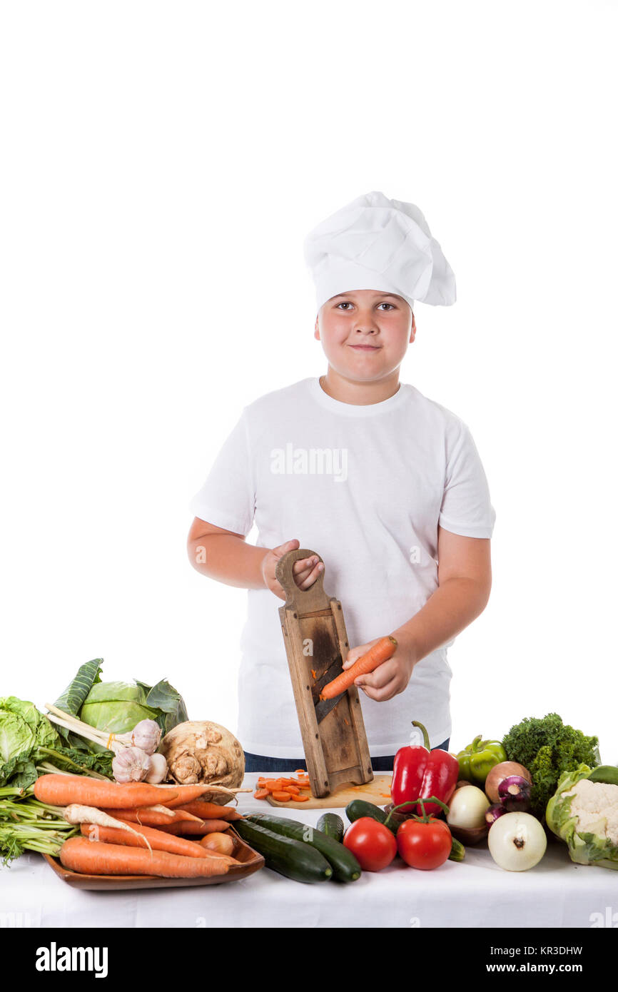 One little boy as chef cook making salad, cooking with vegetable Stock ...