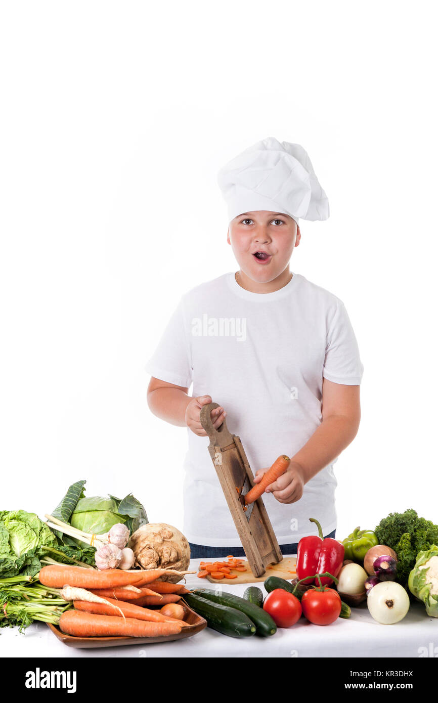 One little boy as chef cook making salad, cooking with vegetable Stock ...