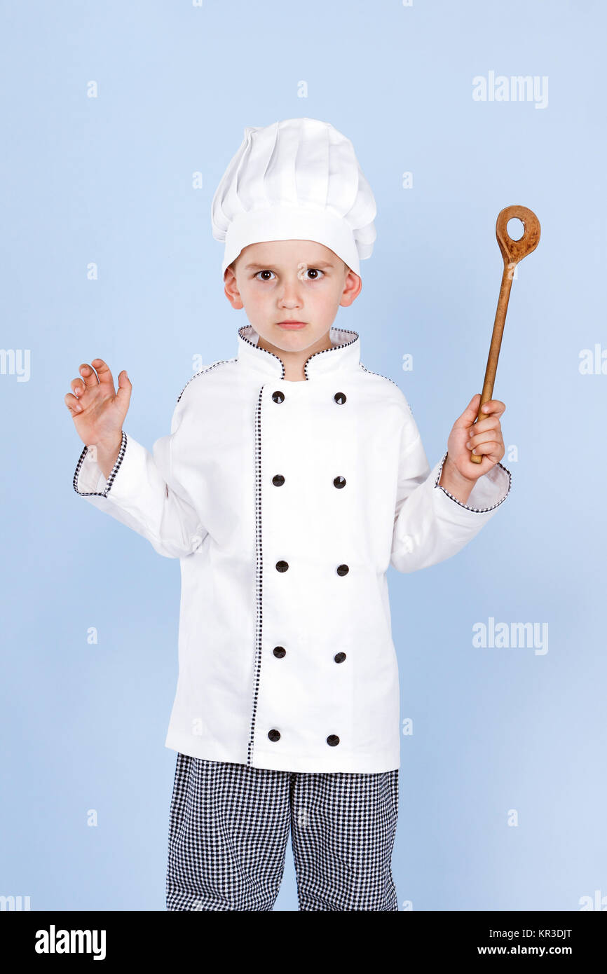 One little boy as chef cook making salad, cooking with vegetable Stock ...