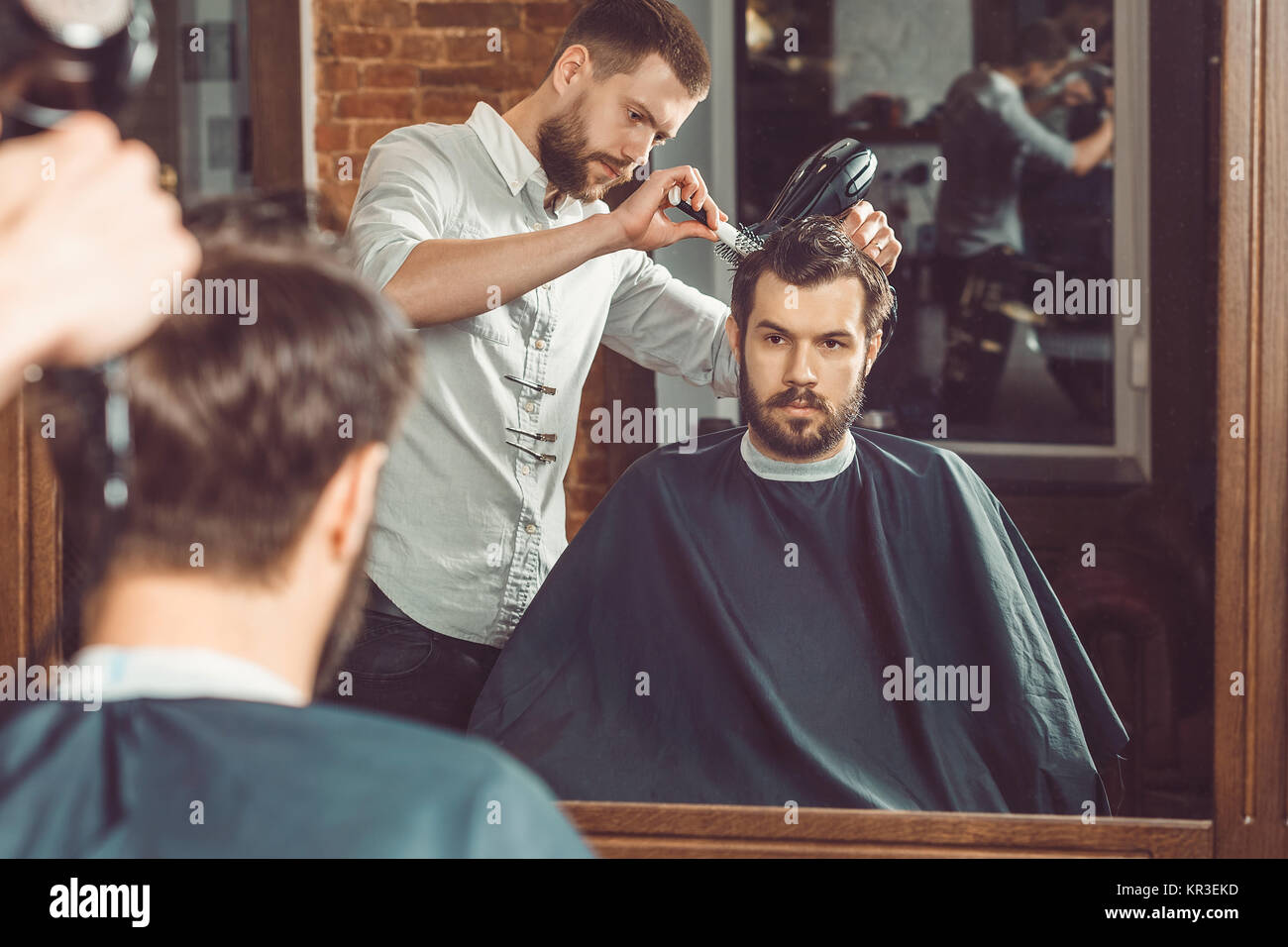 Barber making haircut attractive man hi-res stock photography and ...