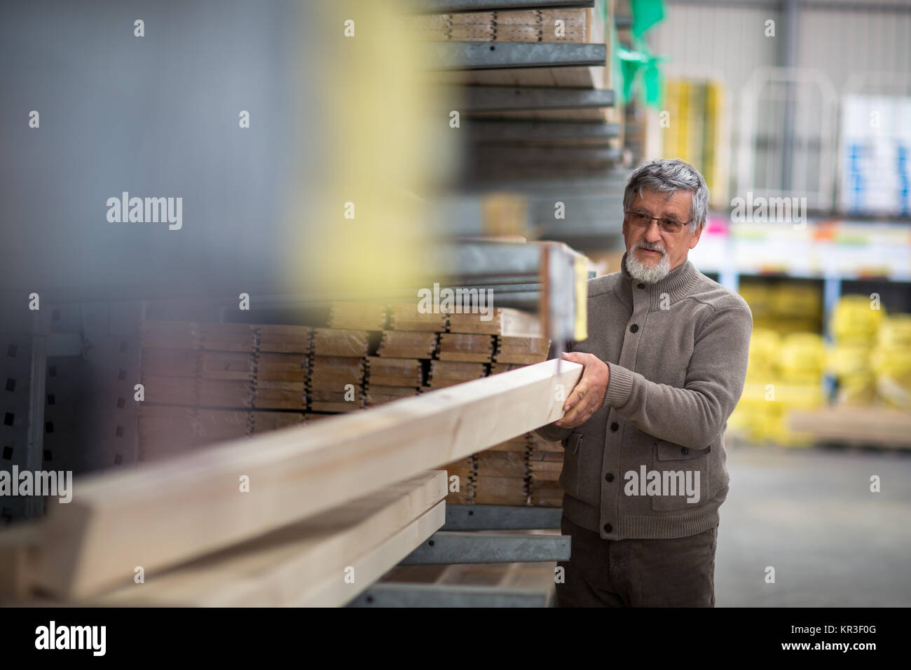 Man choosing and buying construction wood in a DIY store for his DIY ...