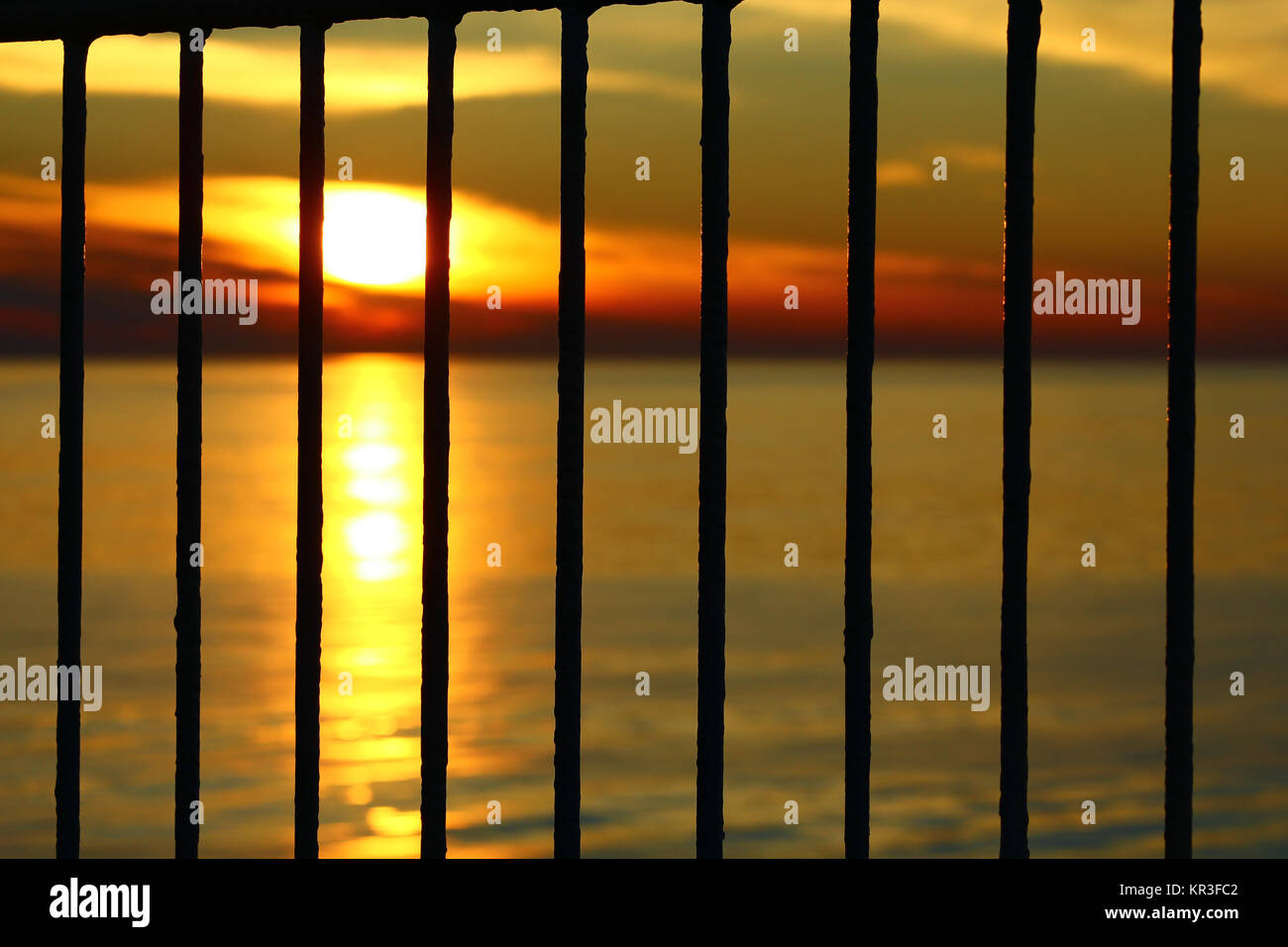 The sunset behind the bars Stock Photo - Alamy