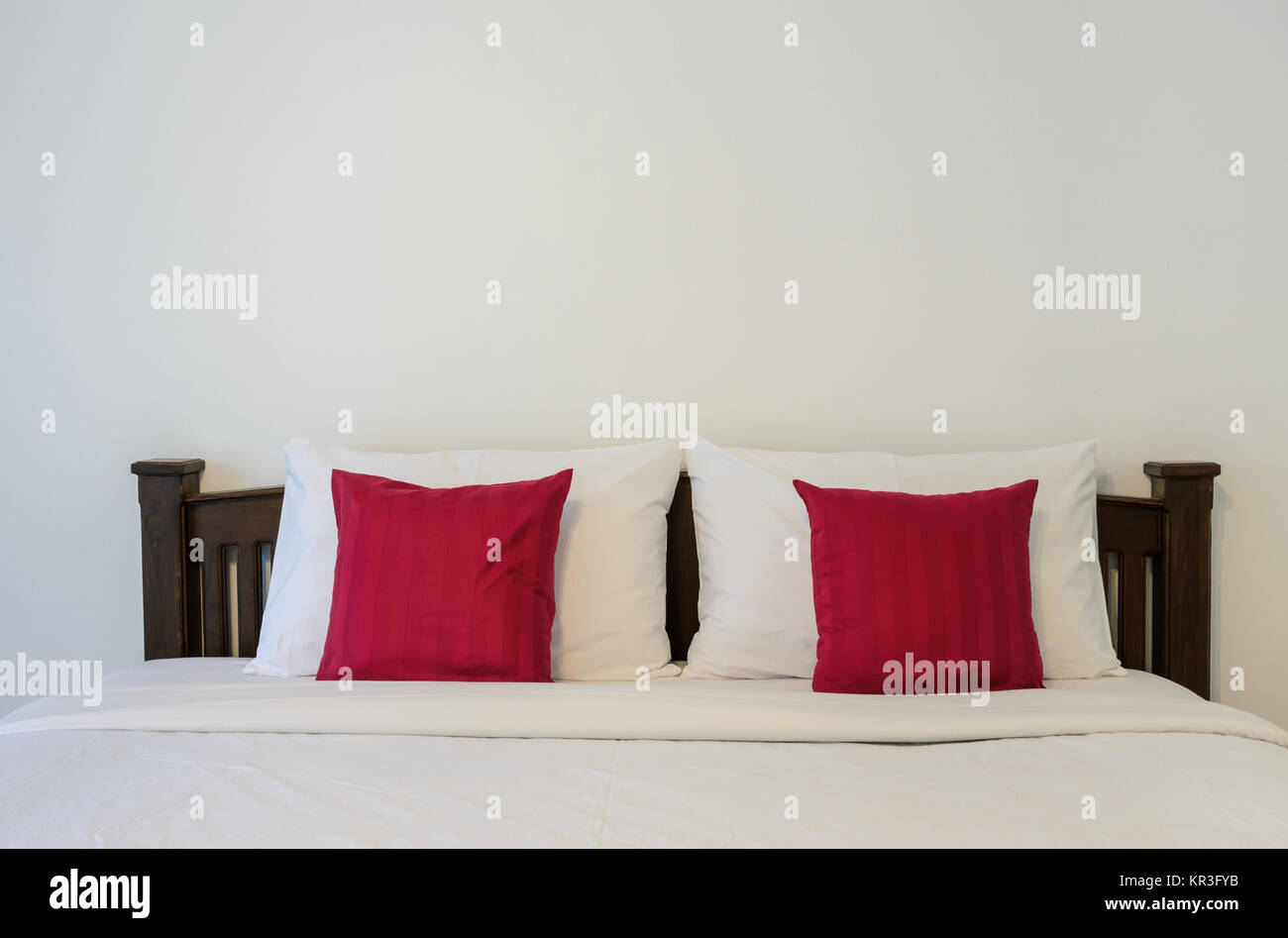 White bedroom with tidy white bed Stock Photo - Alamy