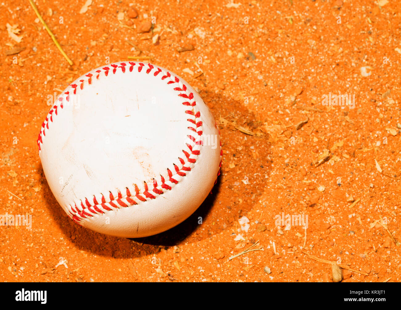Baseball on a red field Stock Photo - Alamy